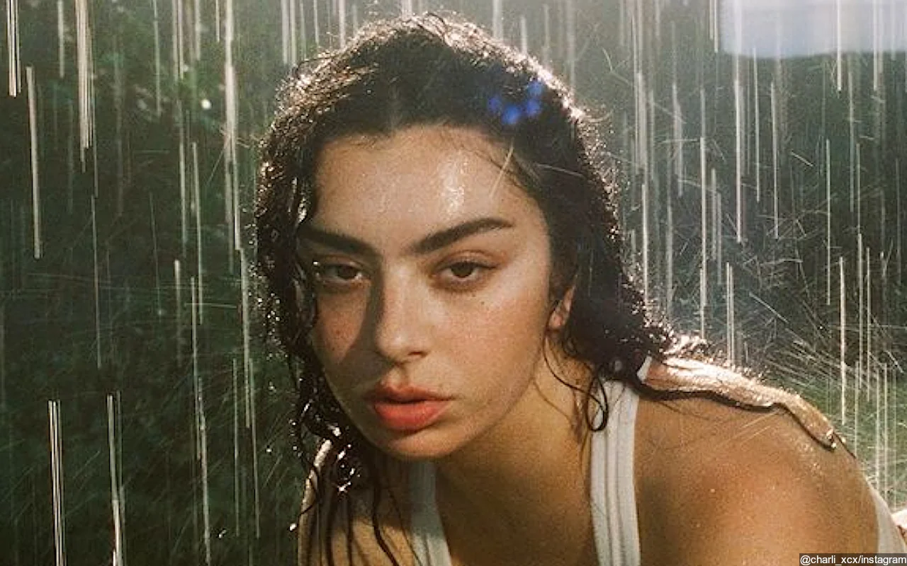 Charli XCX Braves the Rain in Wet Outfit for New SKIMS Campaign